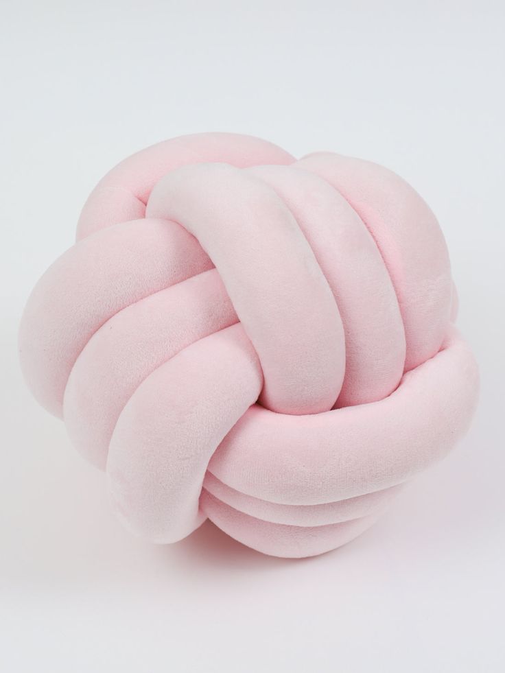 A Pink Knot That Is On Top Of A White Surface
