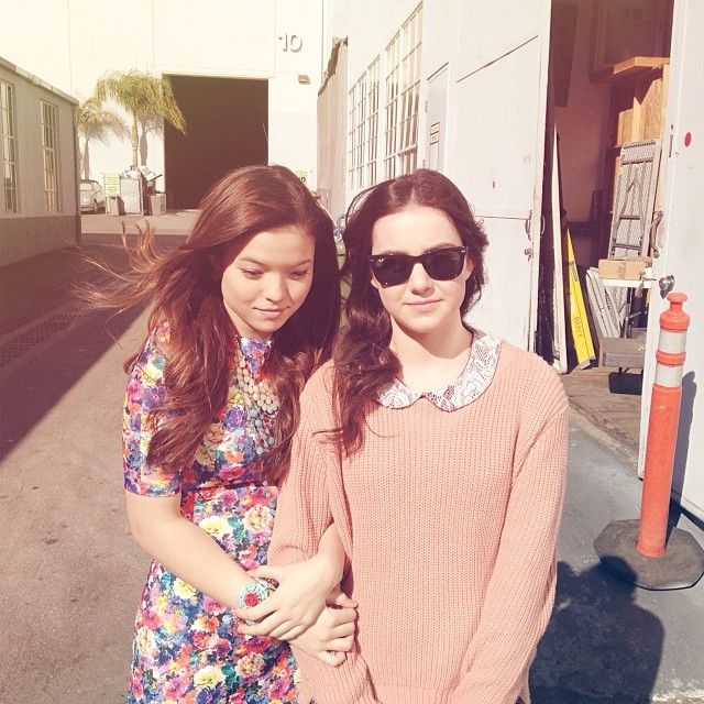 Two Young Women Standing Next To Each Other