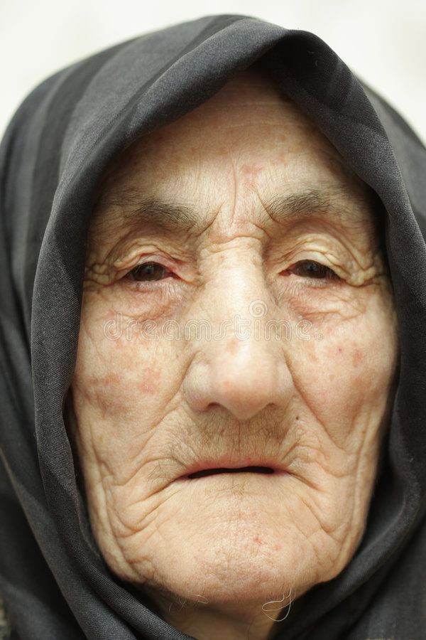 An Old Woman Wearing A Black Hooded Jacket