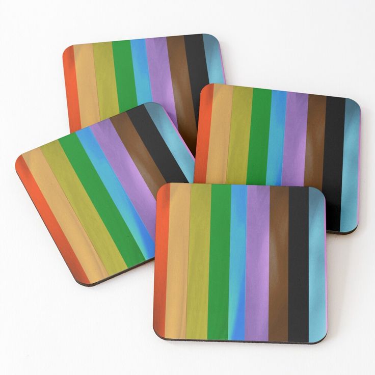 four multicolored striped coasters sitting on top of each other four multicolored striped coasters sitting on top of each other