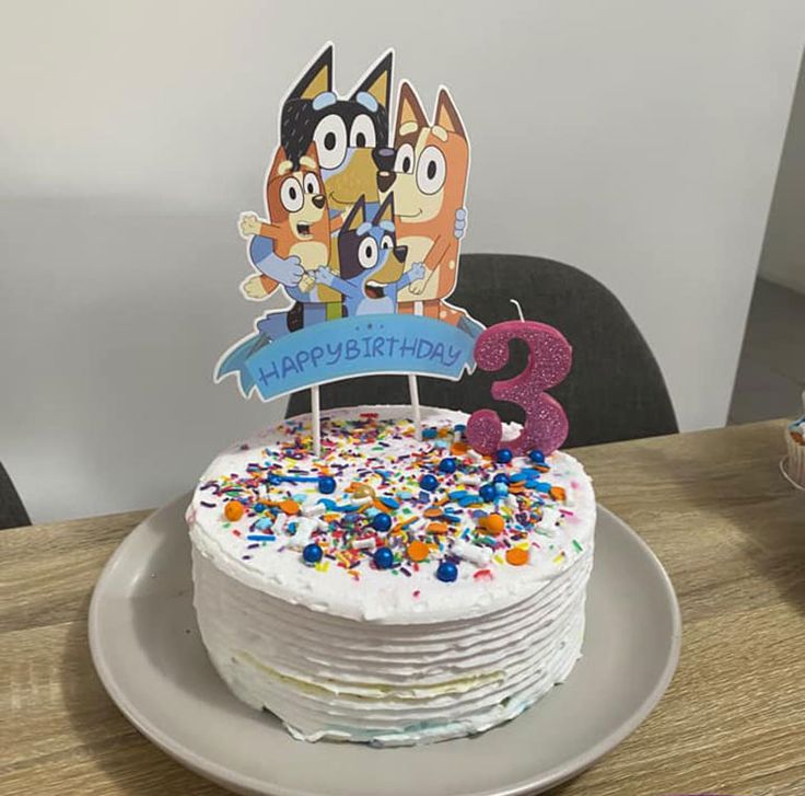 A Birthday Cake With Sprinkles And A Happy 3rd Birthday Sign On Top