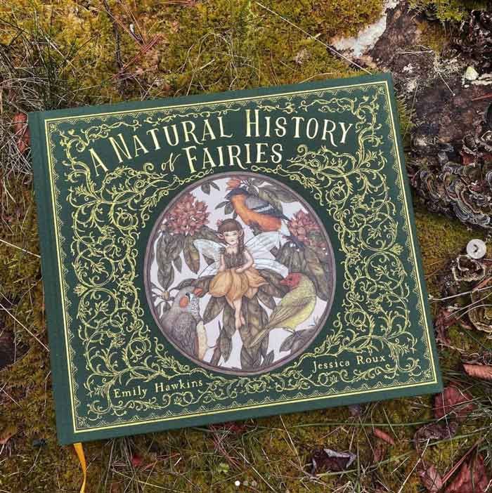 A Book Sitting On The Ground With Moss Growing Around It And An Image
