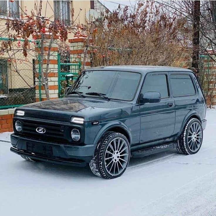 An Suv Is Parked In The Snow Outside