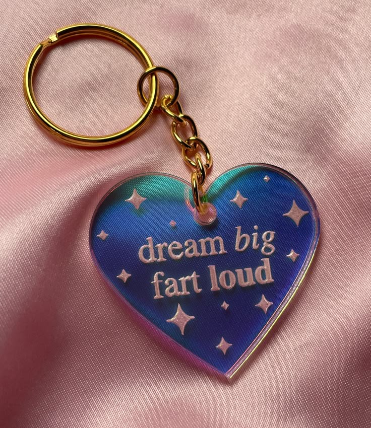 a heart shaped keychain that says, dream big far loud a heart shaped keychain that says, dream big far loud
