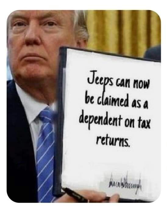 A Man Holding Up A Sign That Says Jeeps Can Now Be Claimed As A Dependent On Tax Returns