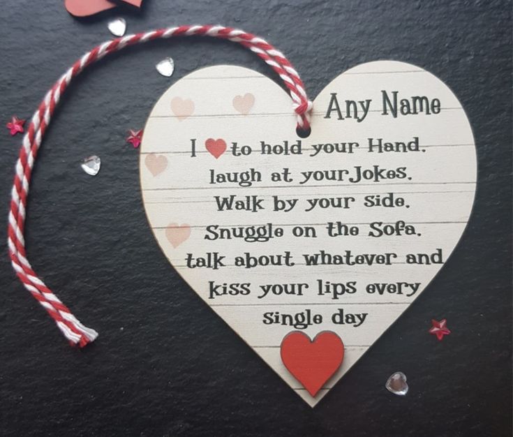 a wooden heart hanging on a wall with some candy canes next to it and ... a wooden heart hanging on a wall with some candy canes next to it and ...