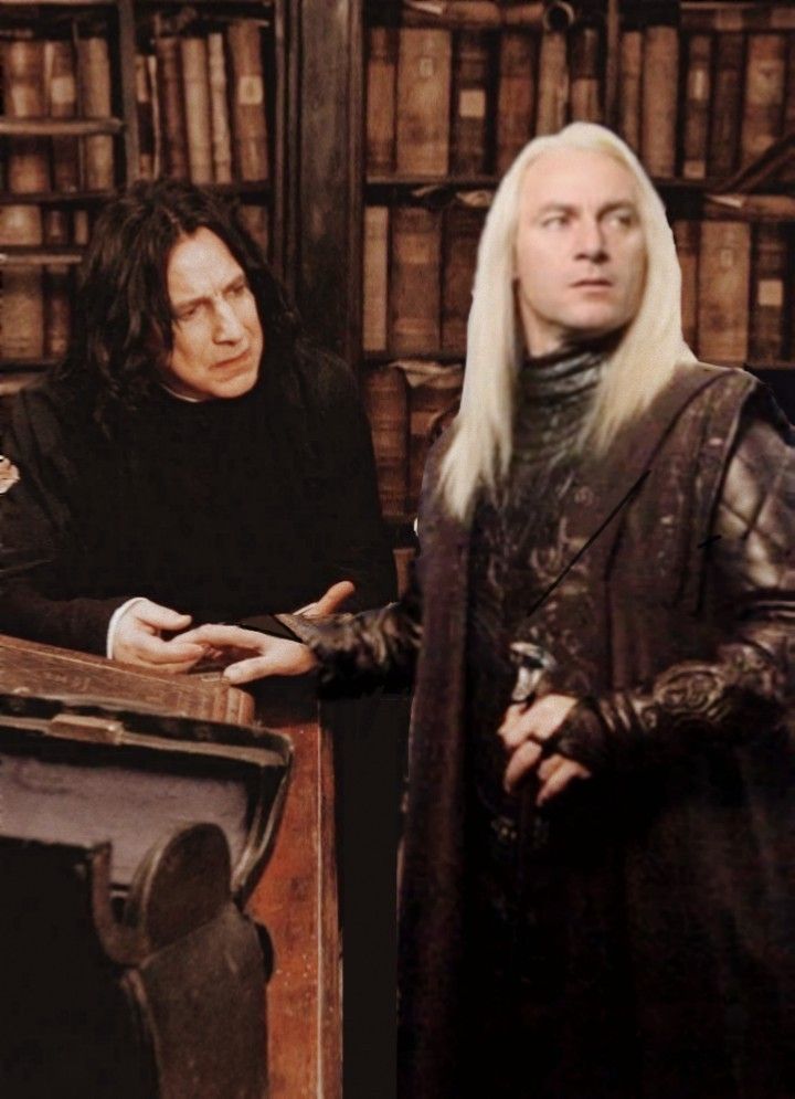 Two People Standing Next To Each Other In Front Of Bookshelves