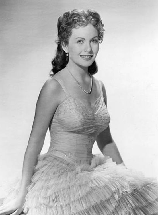 An Old Black And White Photo Of A Woman In A Dress