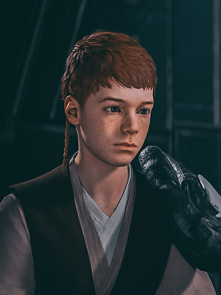 A Young Man With Red Hair Wearing A Star Wars Outfit And Holding A Black Glove