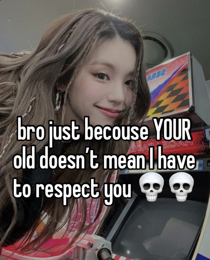 A Girl With Long Hair And Skulls On Her Chest Holding An Object In Front Of Her Face