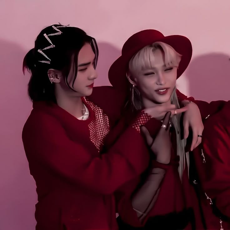 two women in red jackets and hats standing next to each other two women in red jackets and hats standing next to each other