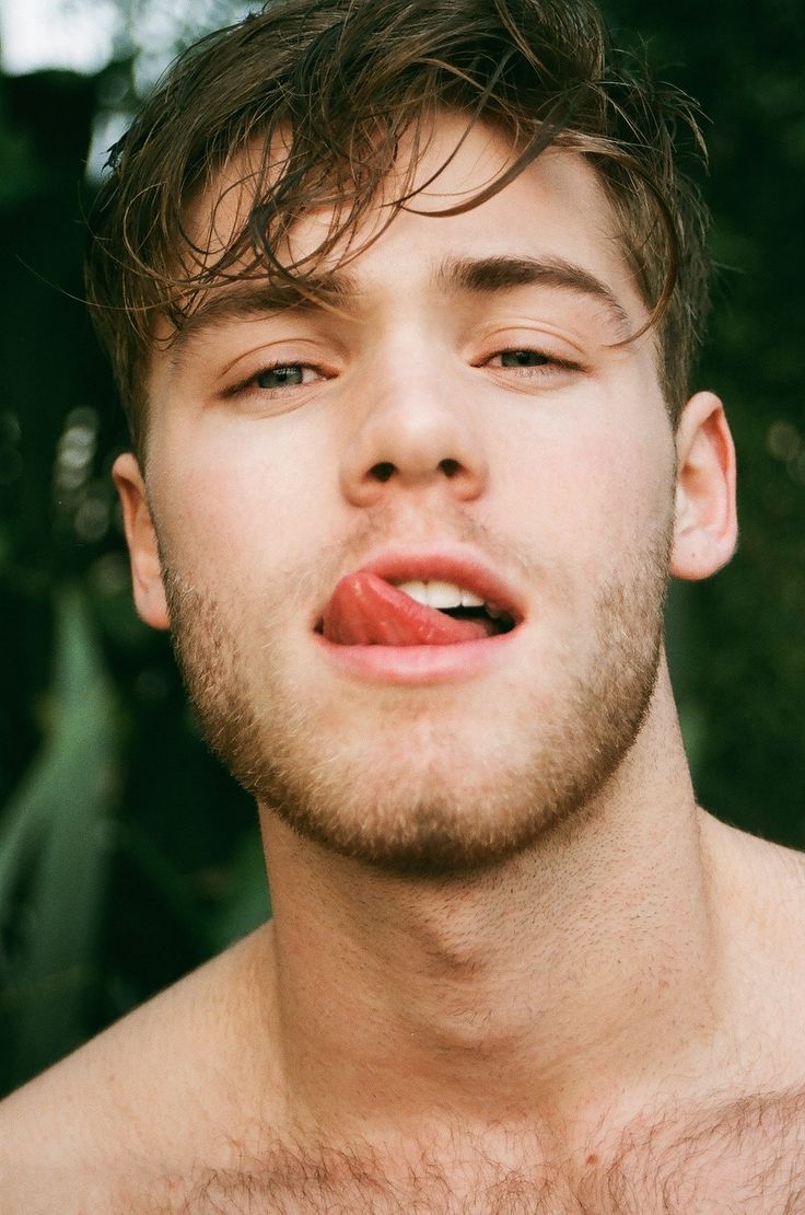A Close Up Of A Person With No Shirt On And His Mouth Open To The Side