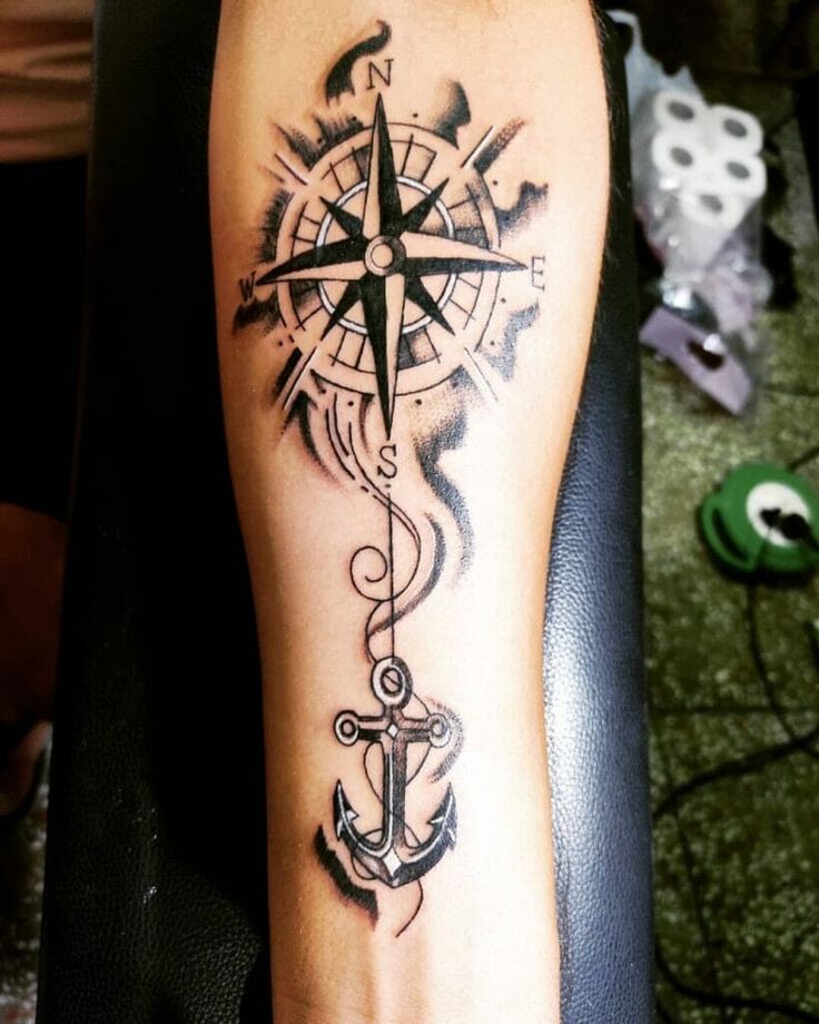 An Anchor And Compass Tattoo On The Arm
