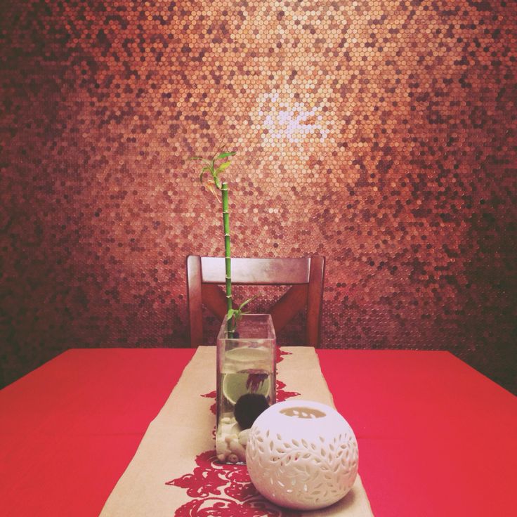 A Table With A Vase And Flower On It