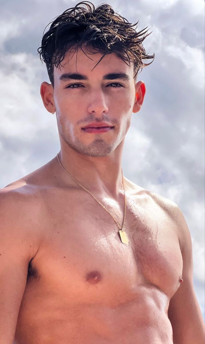 A Man With No Shirt On Posing For A Photo