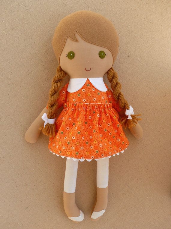 The Doll Is Wearing An Orange Dress