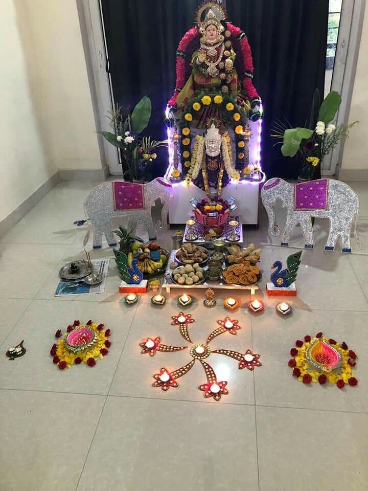 An Idol Sitting On Top Of A Table Surrounded By Candles And Other
