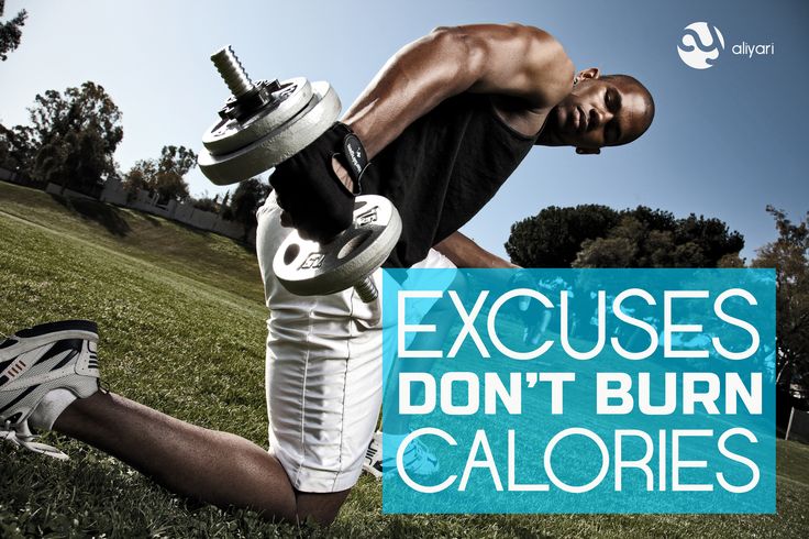 A Man Is Doing Exercises With Dumbbells On The Grass In Front Of Trees
