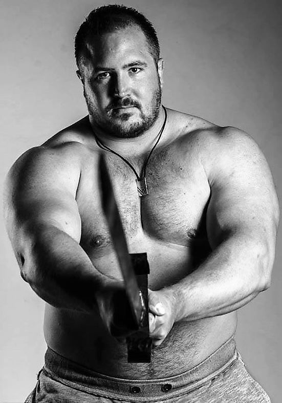 A Man With No Shirt Holding A Knife
