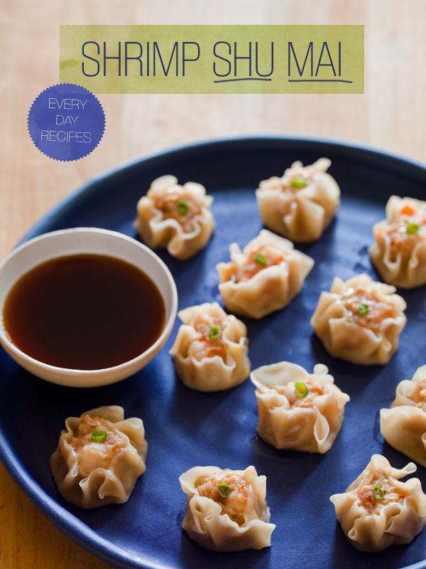 Dumplings On A Blue Plate With Dipping Sauce Next To It And The Words