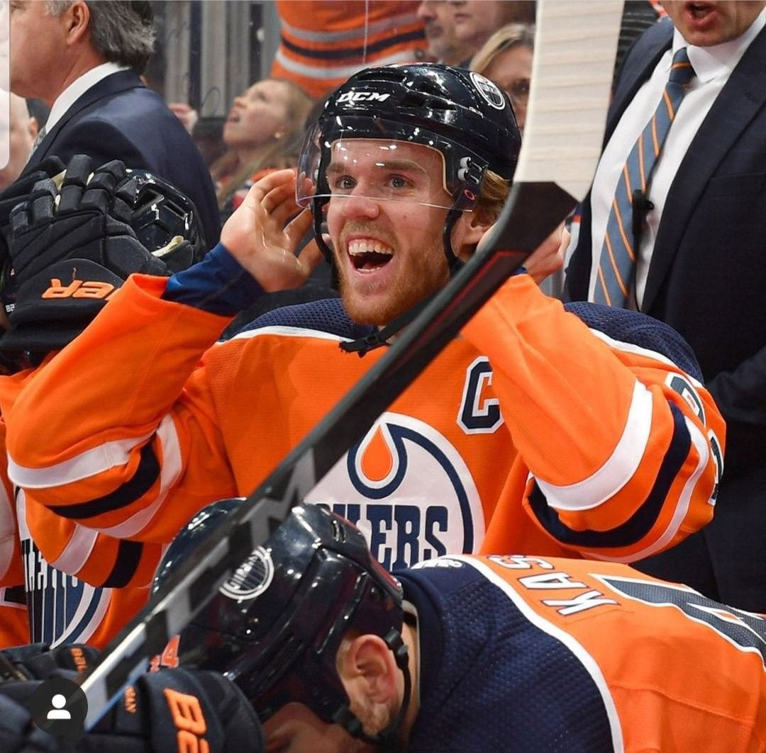 two hockey players are talking to each other two hockey players are talking to each other